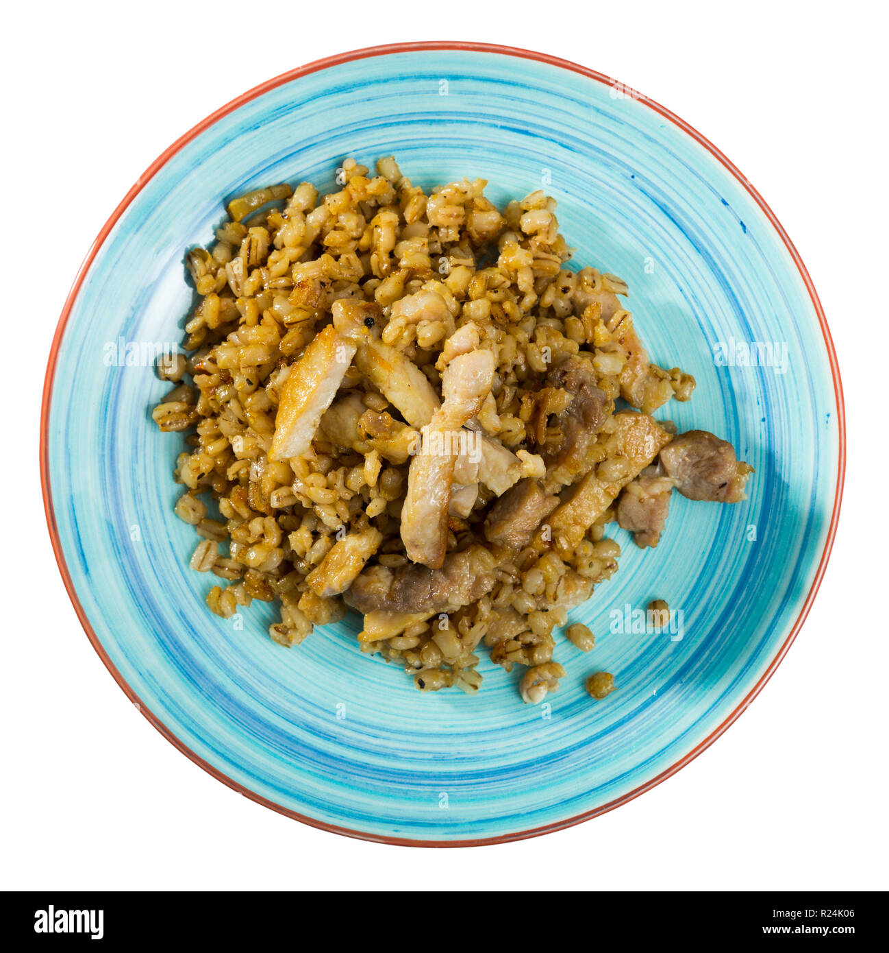 plate with barley porridge with pork roast. Isolated over white ...