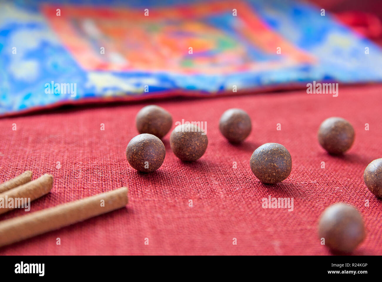 Tibetan herbal mix balls, incense sticks and buddhist thangka Stock ...