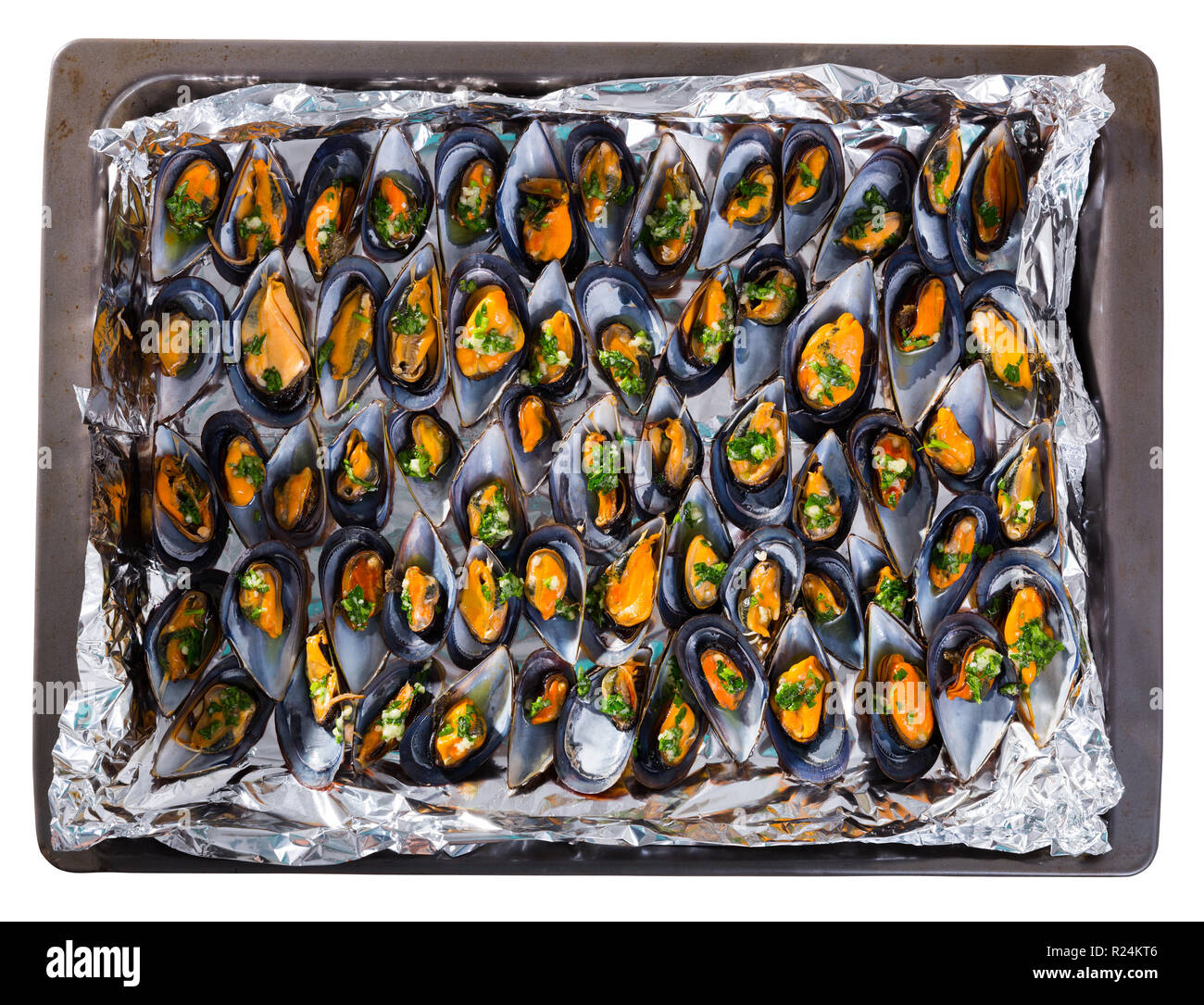 Baking tray with fresh clams in shells with garlic and parsley ...
