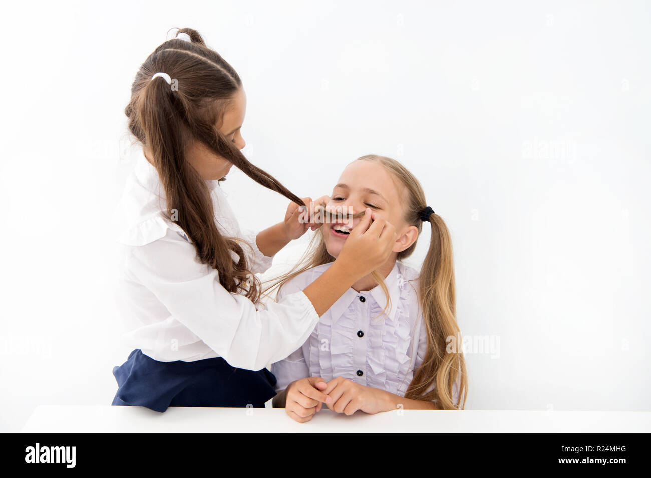 Girls make mustache with long hair. Lets imagine you were boy. Girl cheerful playful mood play ...