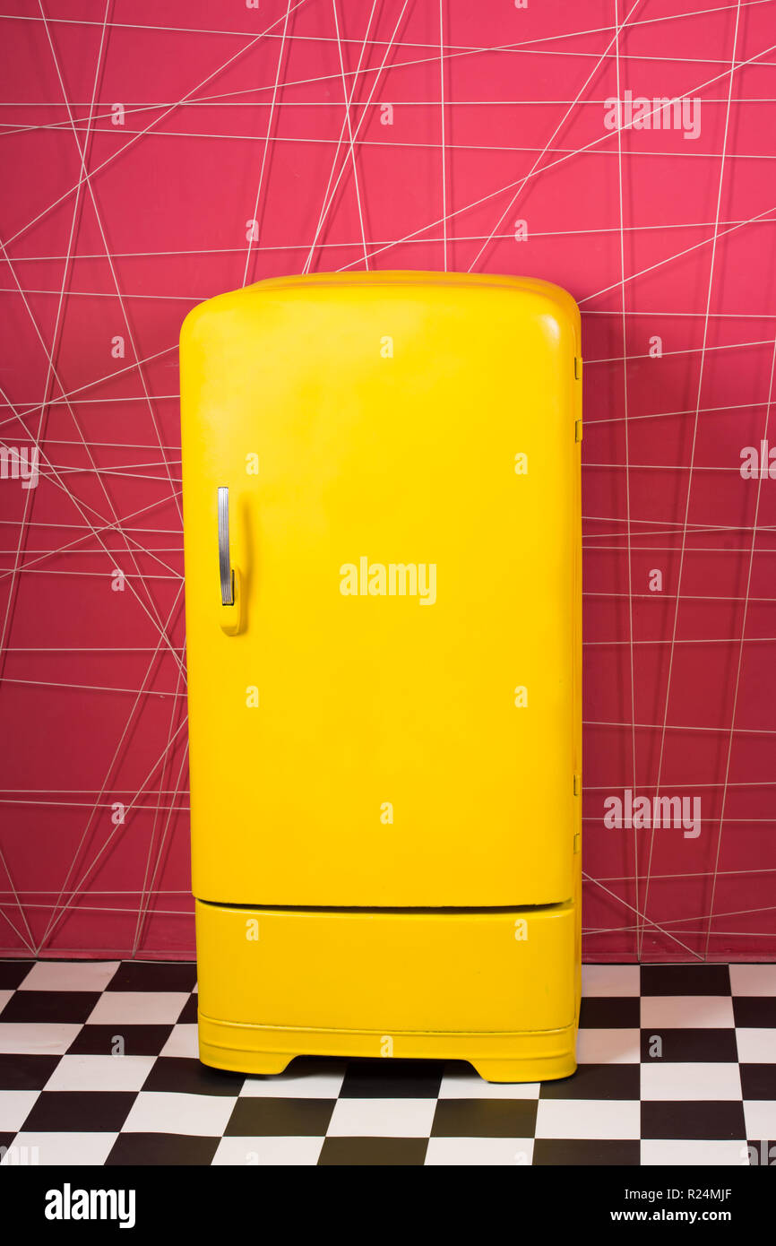 Bright yellow refrigerator in pink interior. Retro fridge looks awesome ...