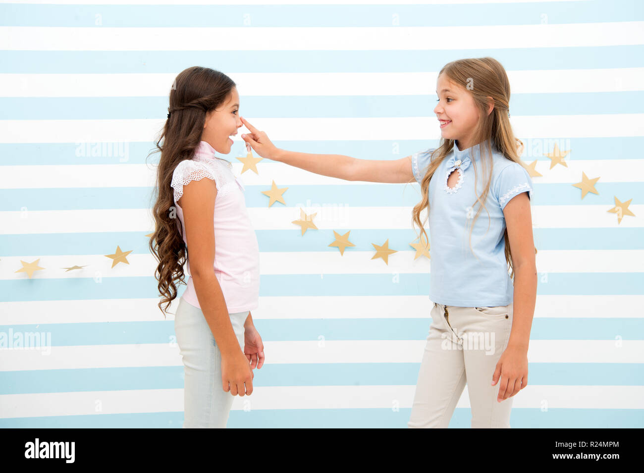 Girls smiling happy faces play or interact stand striped background ...