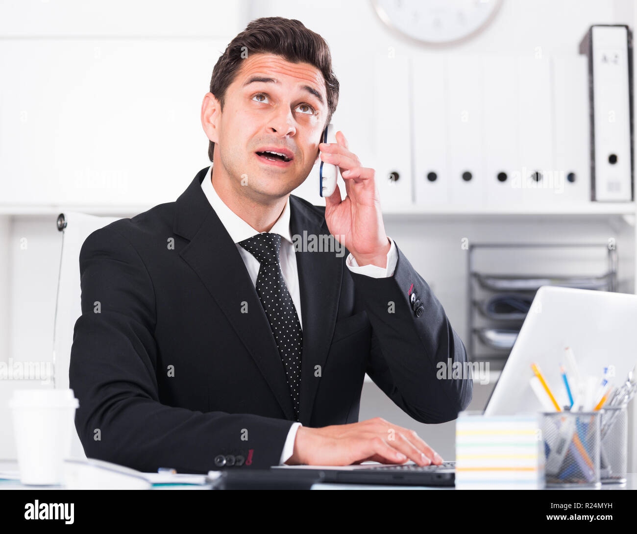 Businessman having phone call conversation at workplace in office Stock ...