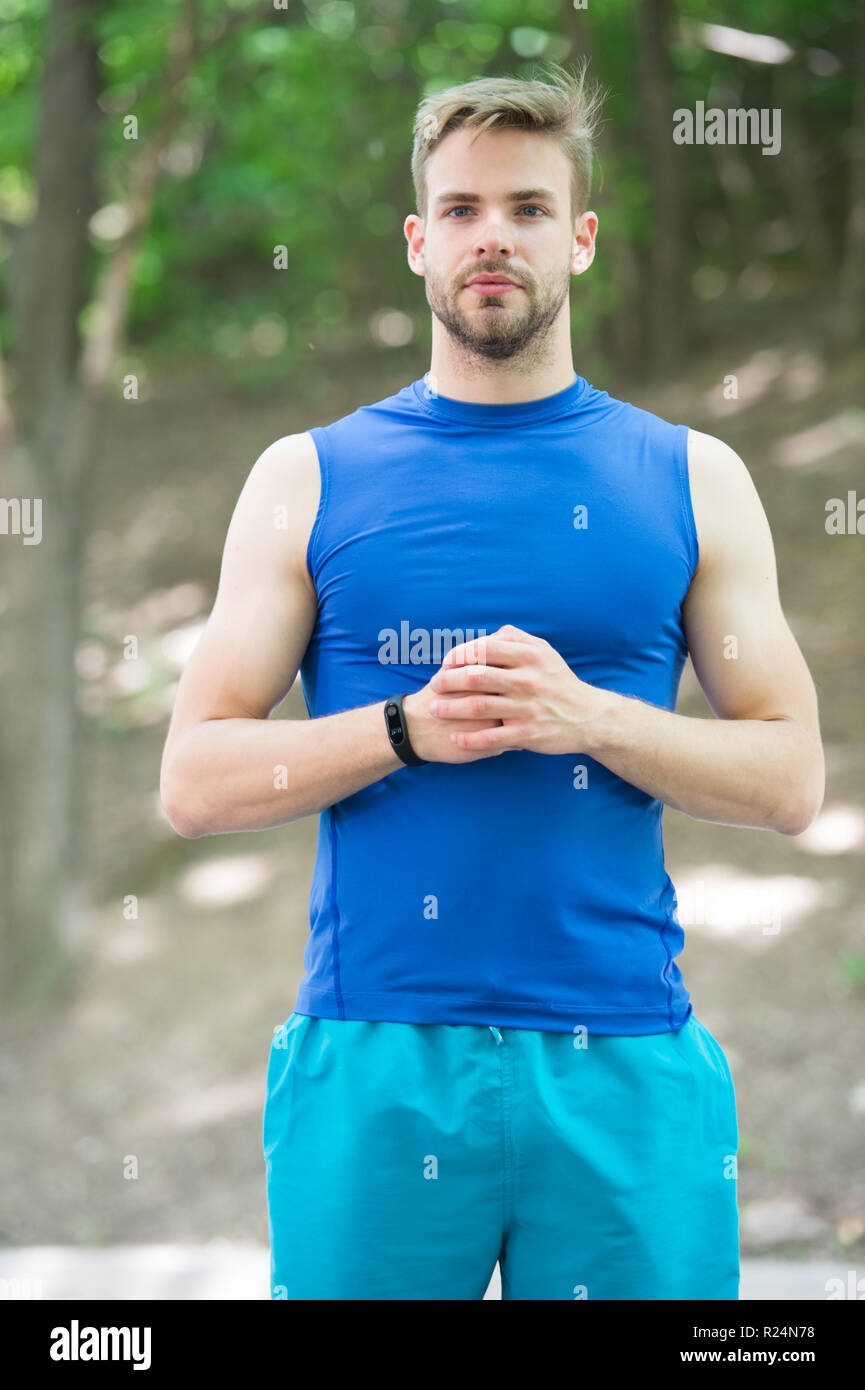 Man sporty outfit looks confident outdoors nature background. Guy ...