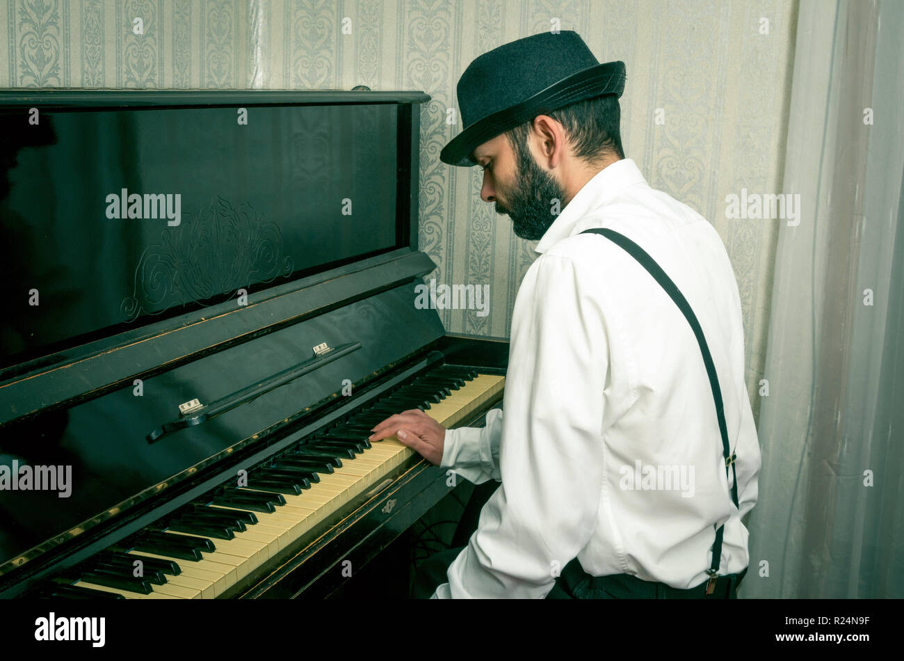 Retro man playing the piano Stock Photo - Alamy