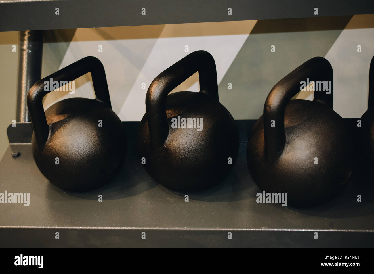 Steel gym kettles on metal stand in the view Stock Photo - Alamy
