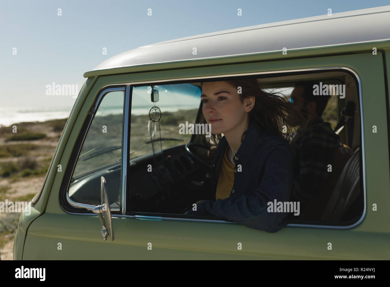 Woman looking through car window Stock Photo - Alamy