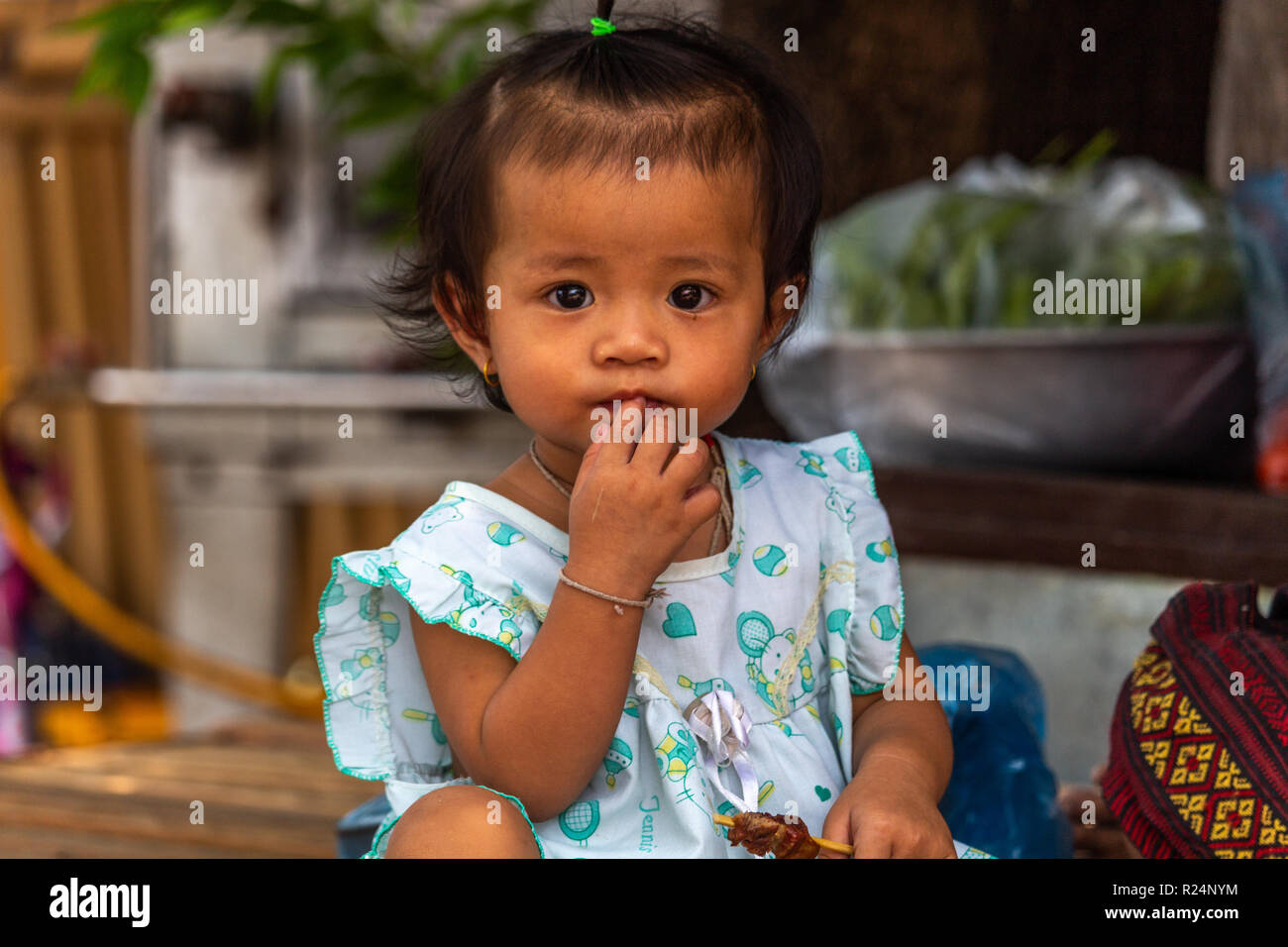 Don Det, Laos - April 25, 2018: Portrait of a child looking at the ...