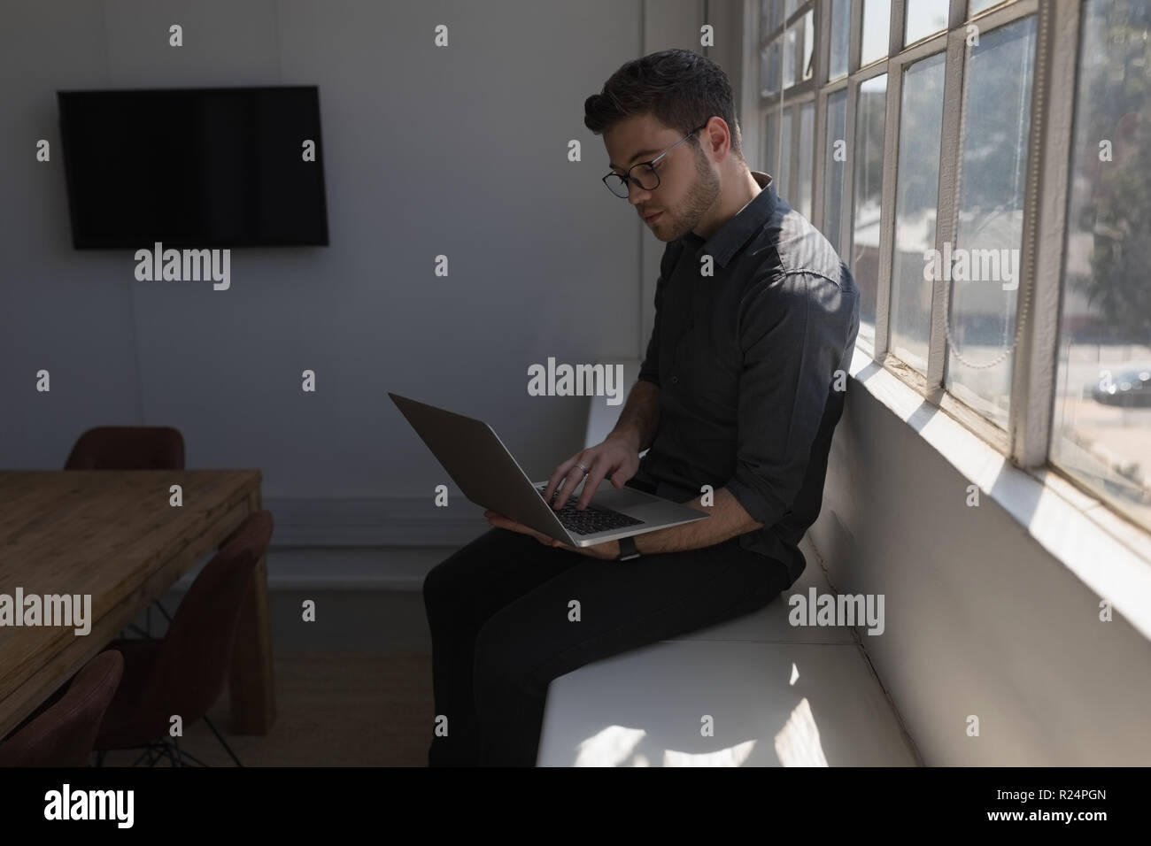 Executive using laptop in office Stock Photo - Alamy