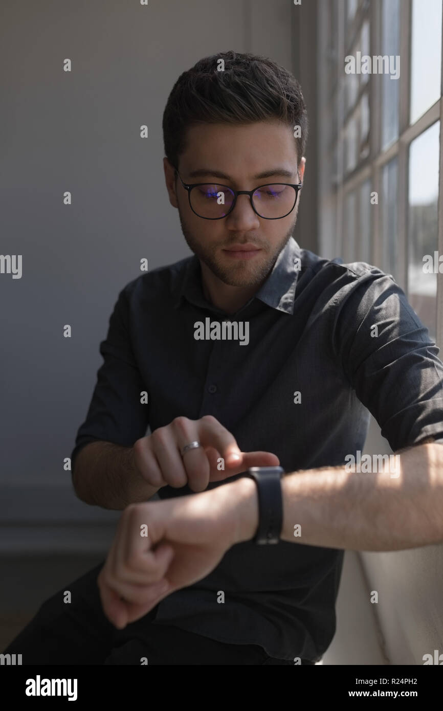 Young man using smartwatch in hi-res stock photography and images - Alamy