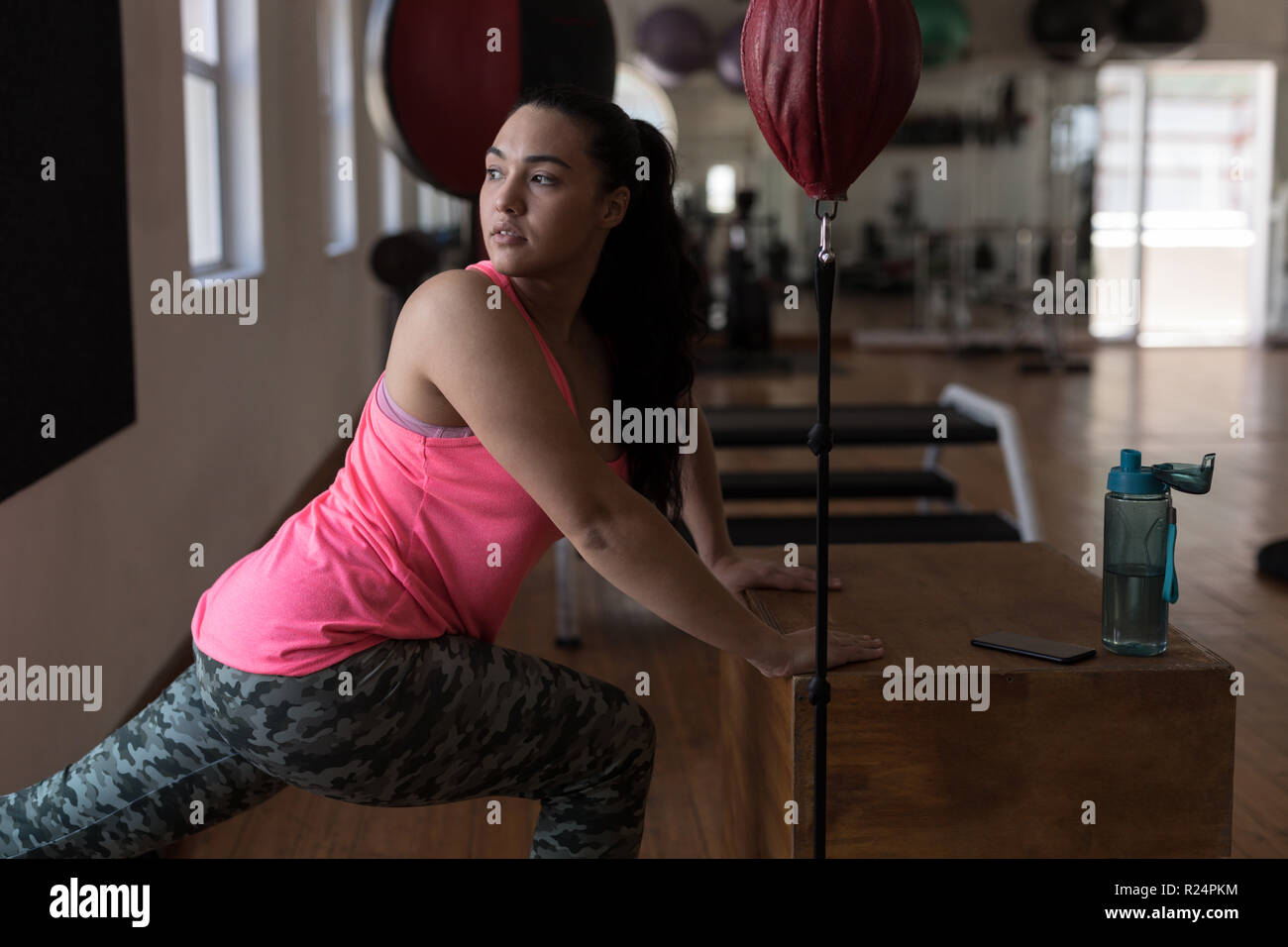 Female boxer stretching in fitness studio Stock Photo - Alamy