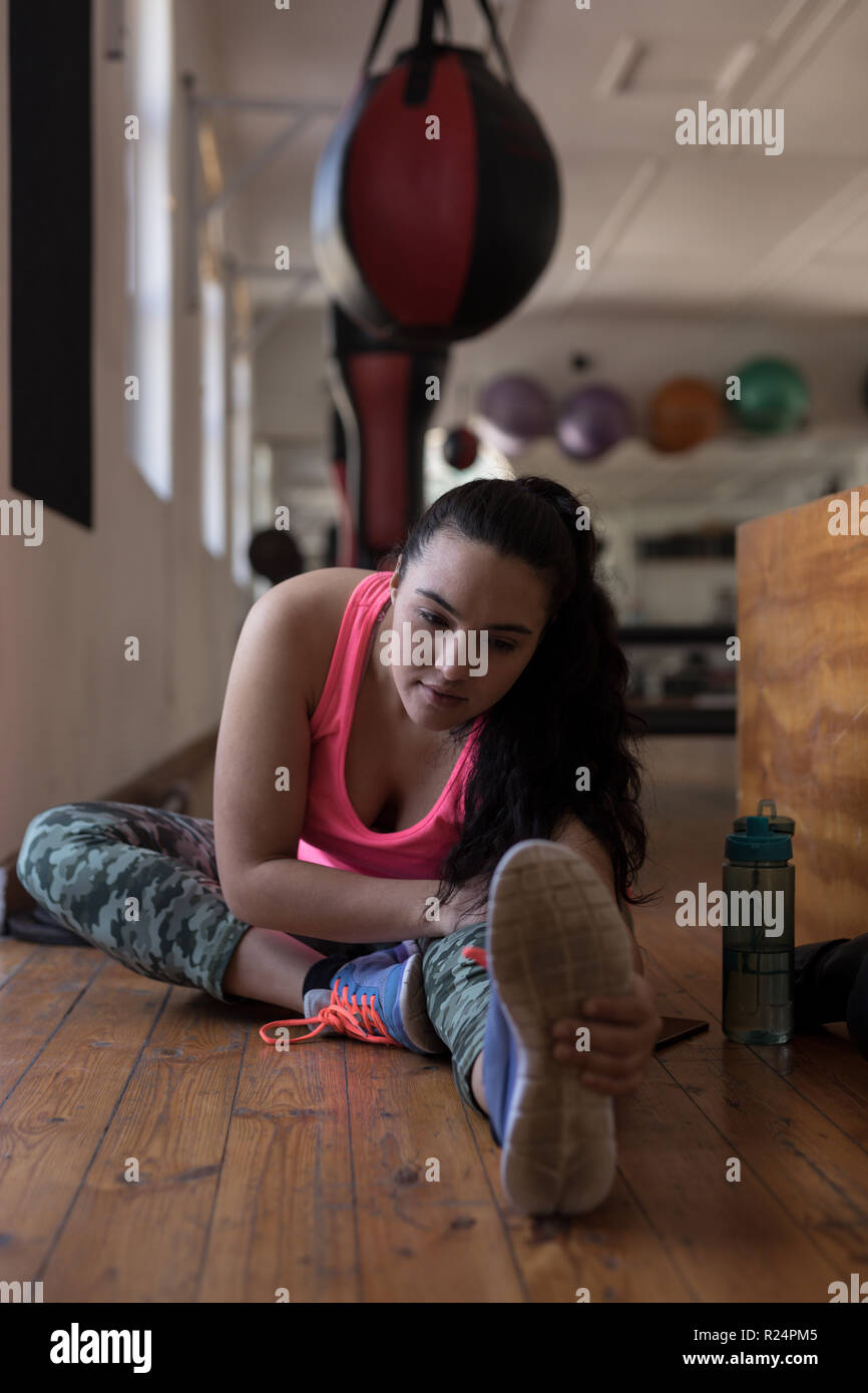 Female boxer stretching in fitness studio Stock Photo - Alamy