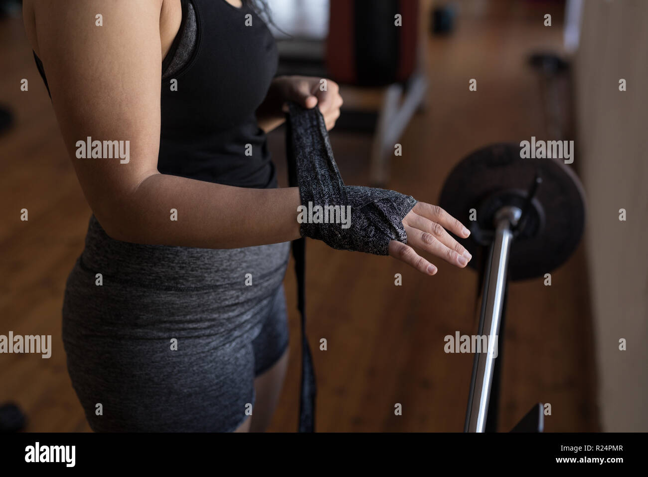 Female boxer wearing hand wrap in fitness studio Stock Photo - Alamy