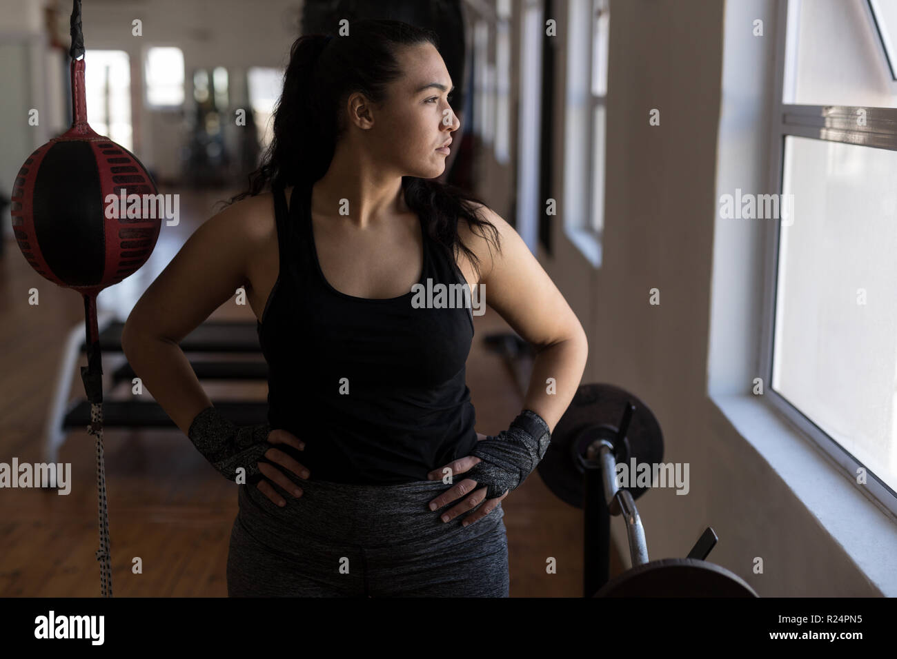 Female boxer looking through window in fitness studio Stock Photo - Alamy