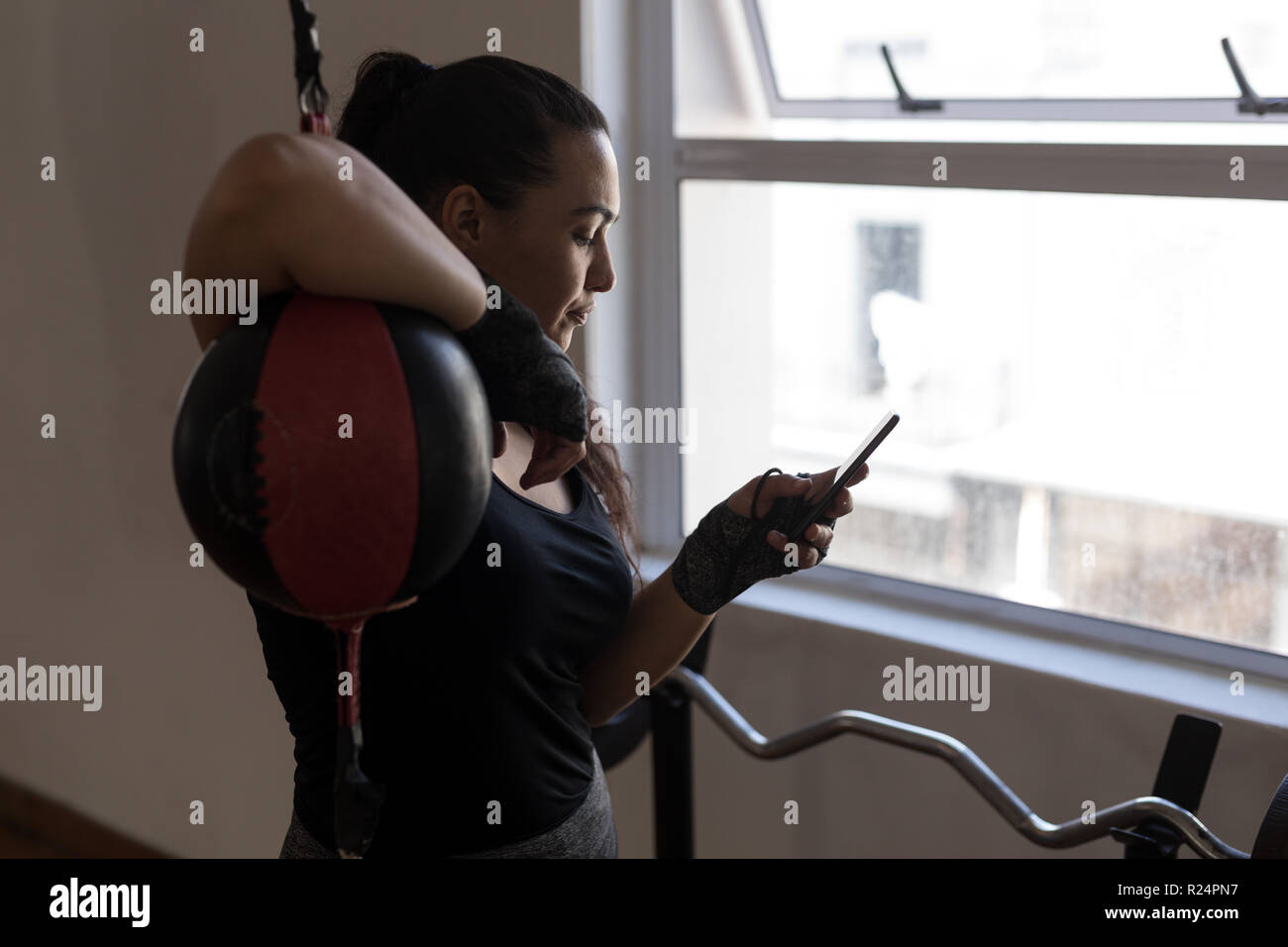 Female boxer using mobile phone in fitness studio Stock Photo - Alamy