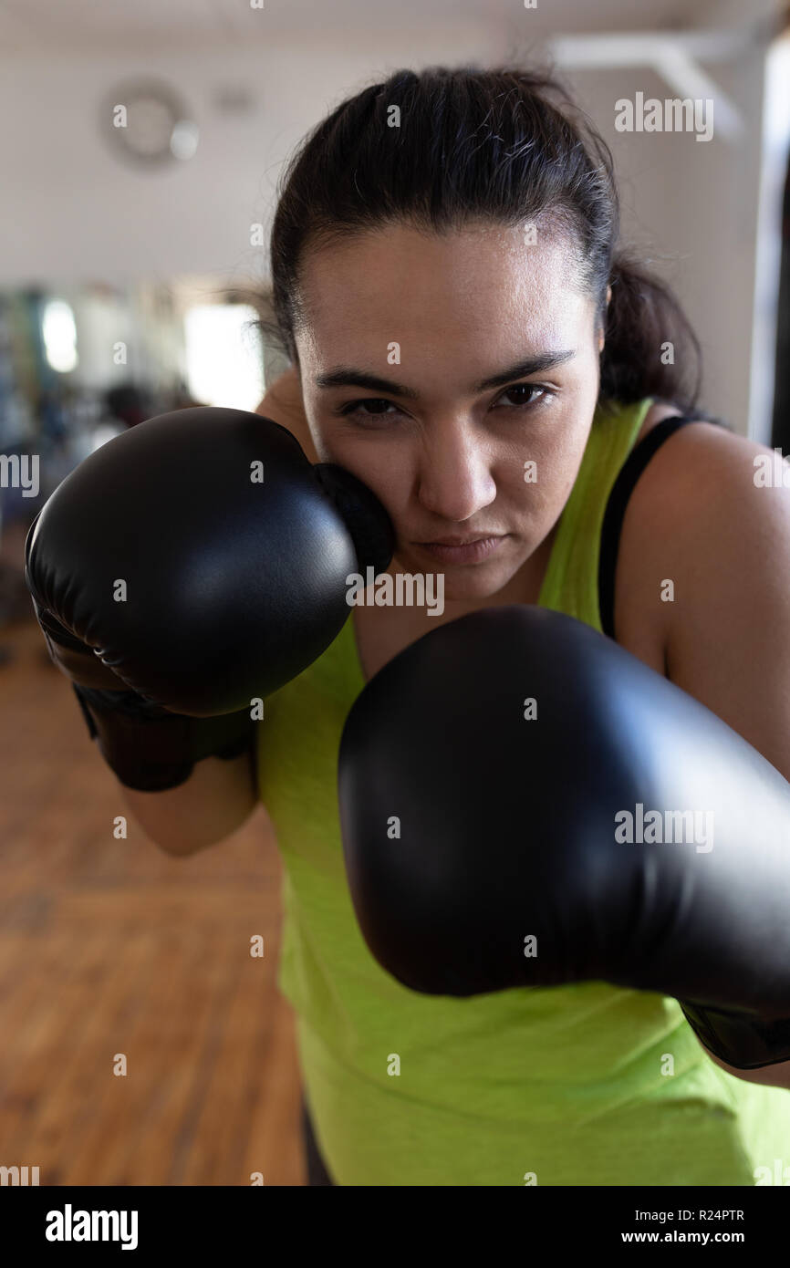 Female boxer practicing boxing in fitness studio Stock Photo - Alamy