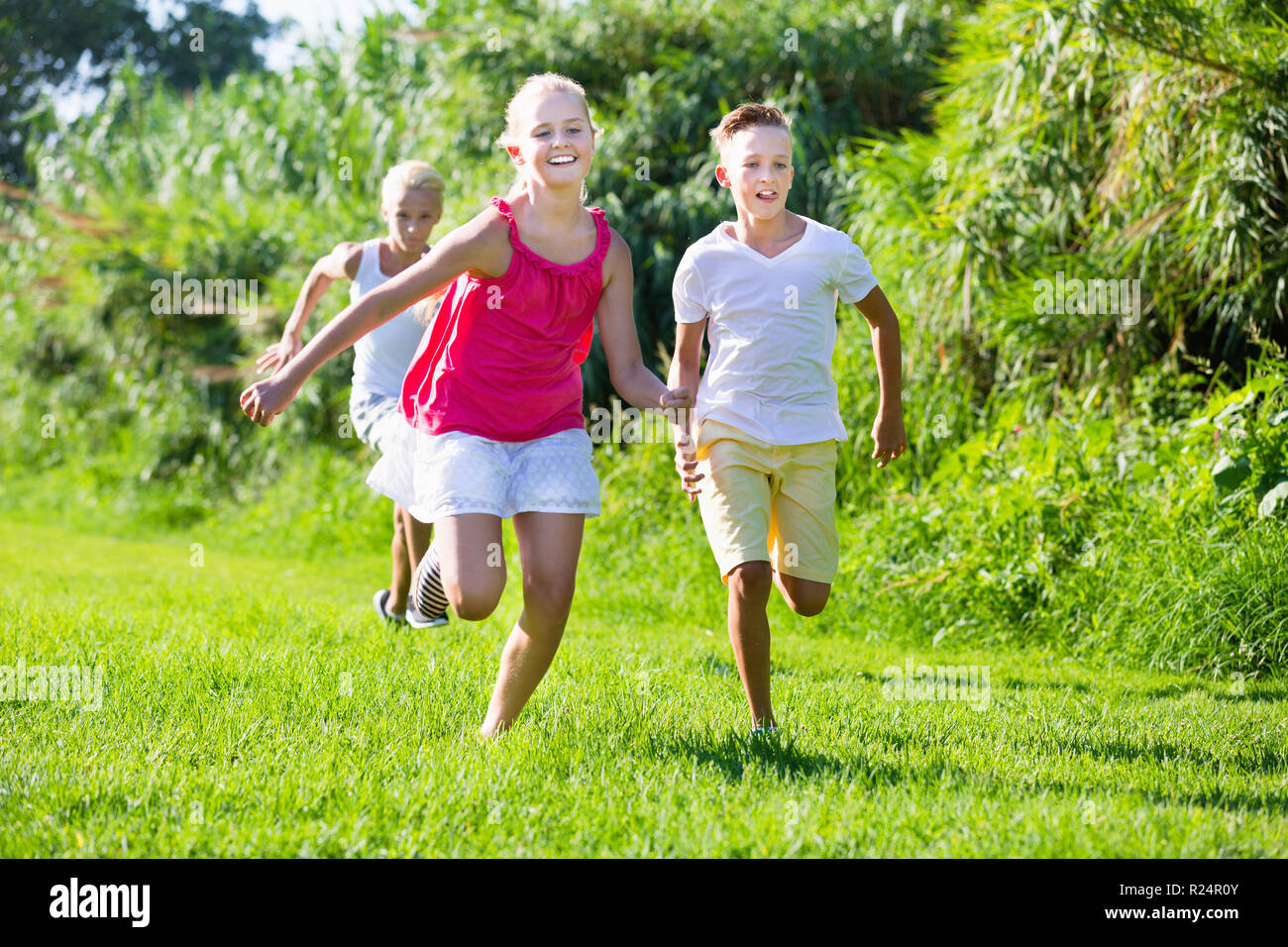 Group of laughing happy positive children having fun together outdoors ...