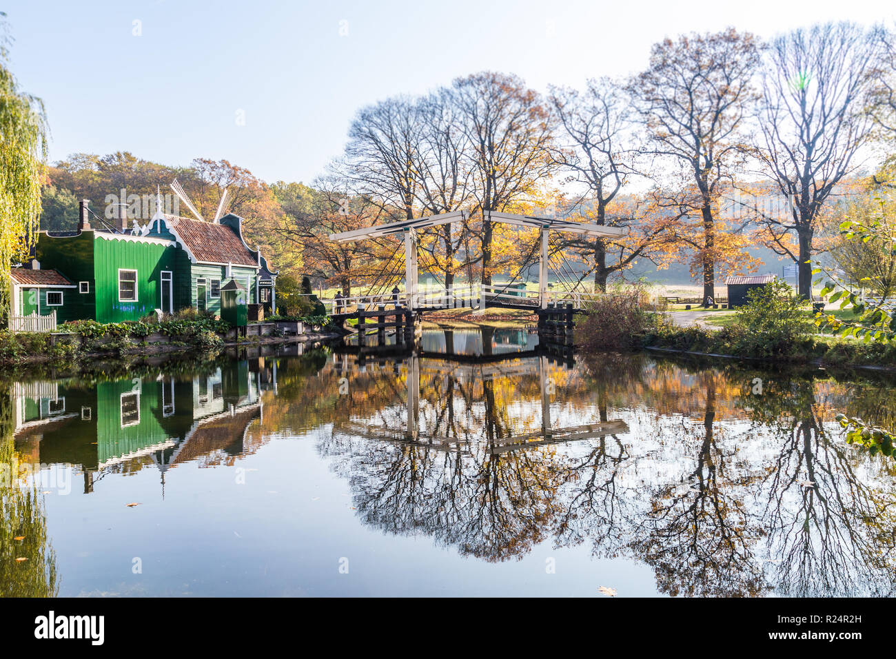 Historic Dutch scene with a bridge, wooden barn and water windmill in ...