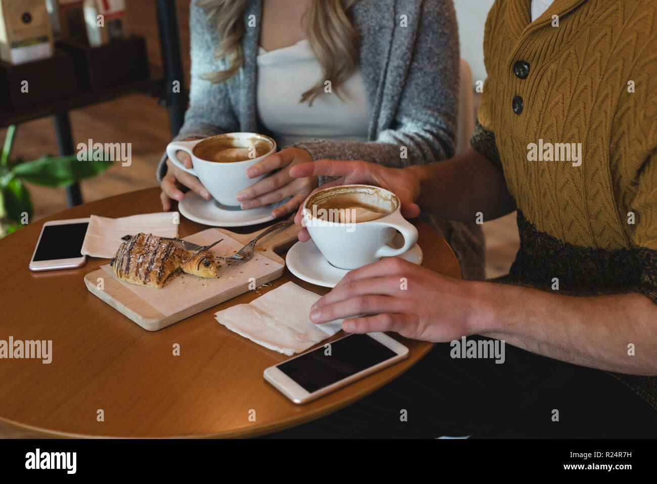 Couple having coffee in cafe Stock Photo - Alamy
