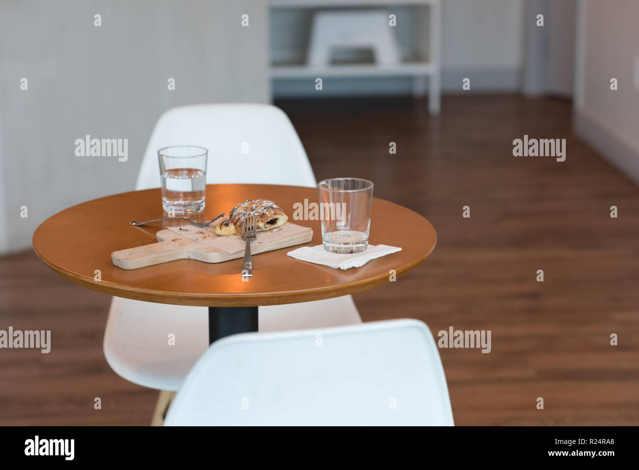 Glass of water and sweet food on table Stock Photo - Alamy