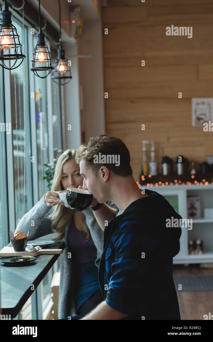 Couple having coffee in cafe Stock Photo - Alamy