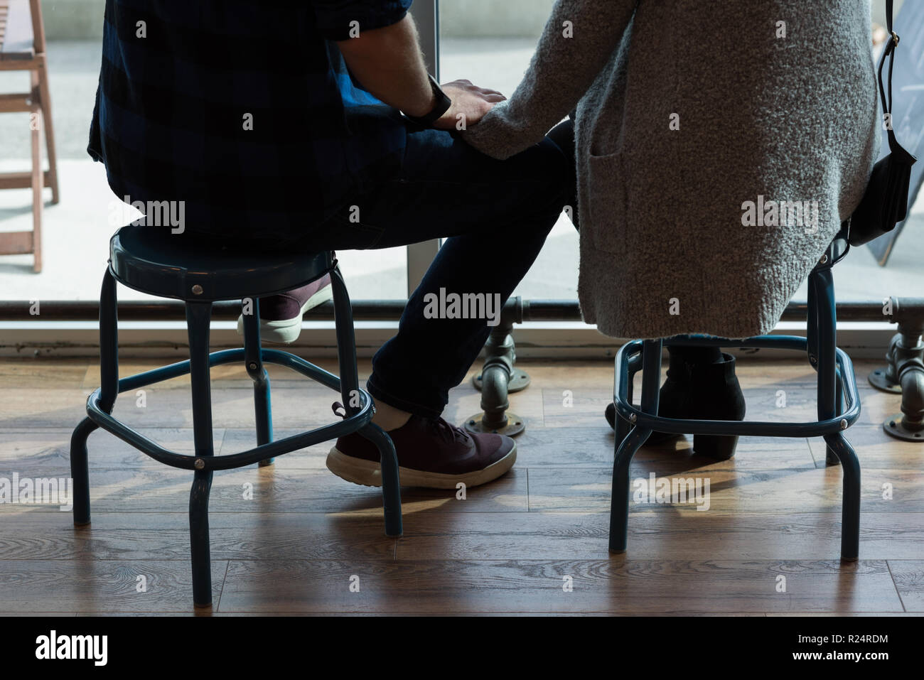 Couple sitting in cafe Stock Photo - Alamy