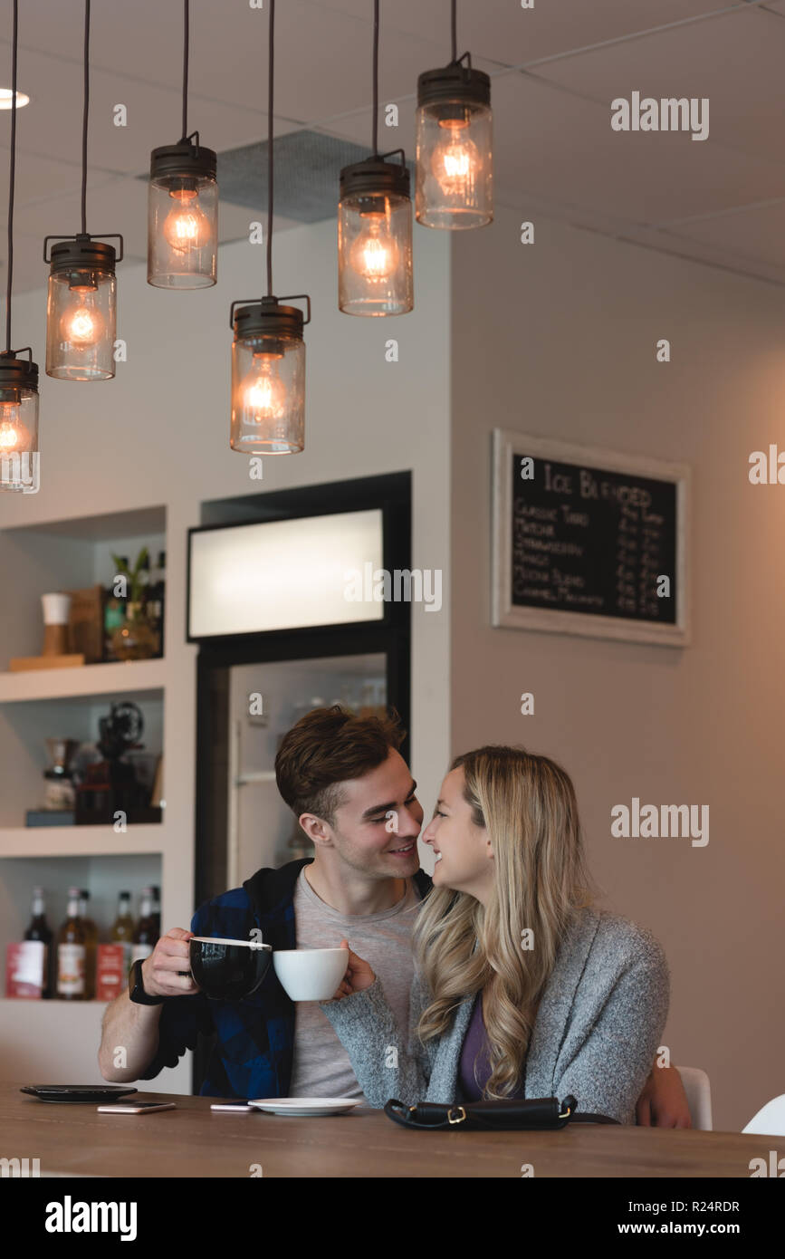 Couple having coffee in cafe Stock Photo - Alamy