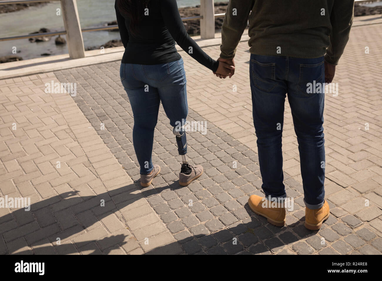 Couple holding hands on promenade Stock Photo - Alamy