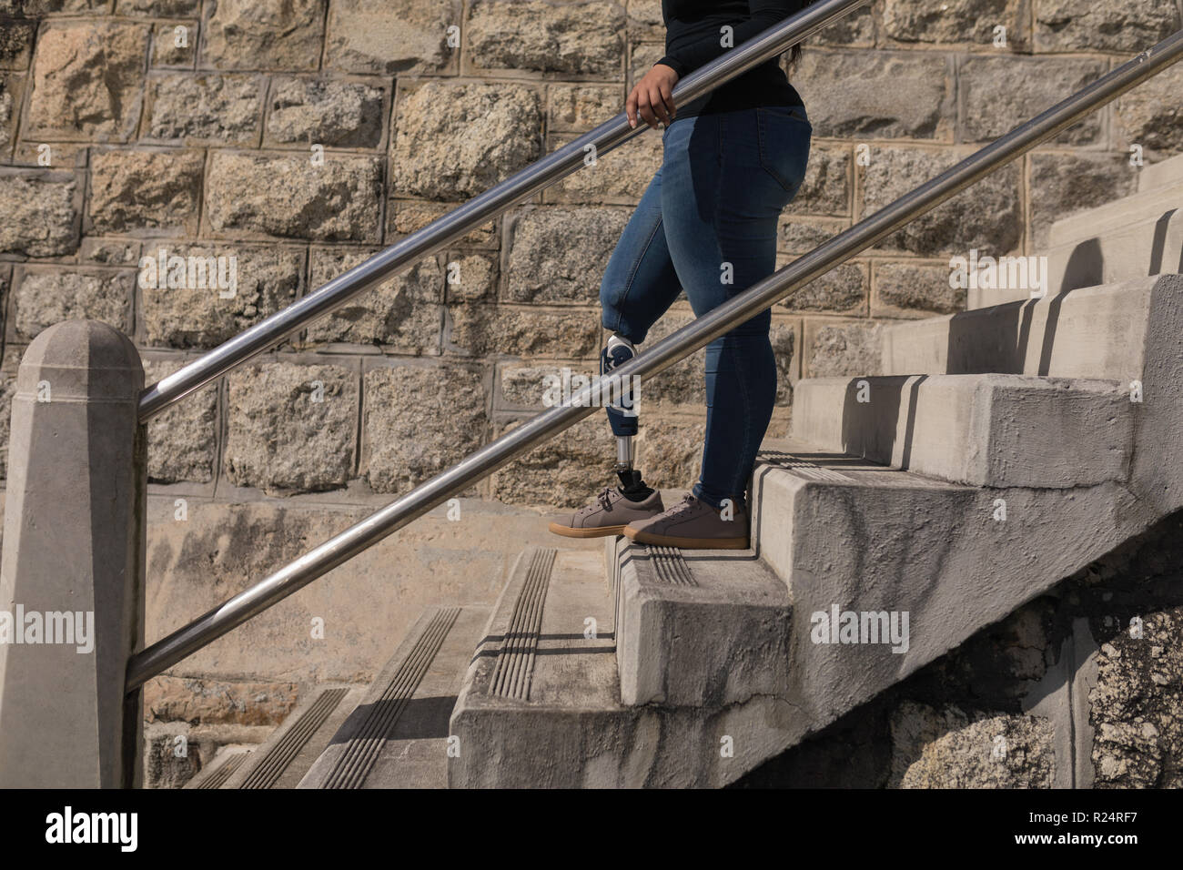 Woman descending stairs hi-res stock photography and images - Alamy
