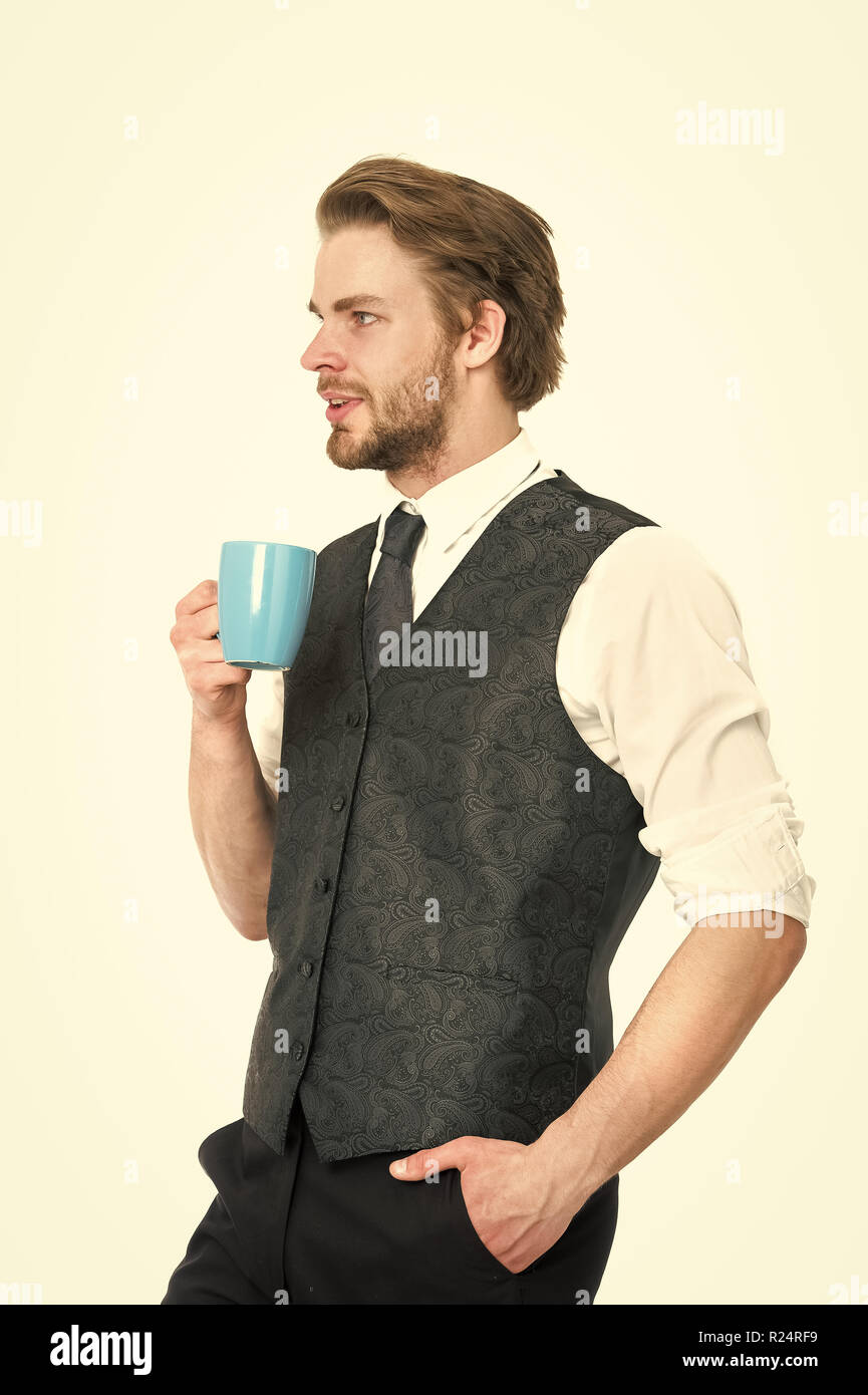 businessman or smiling gentleman in waistcoat and tie drink tea or ...