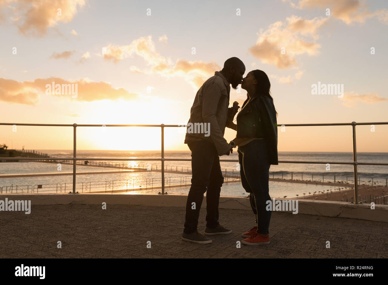Couple kissing on promenade Stock Photo - Alamy