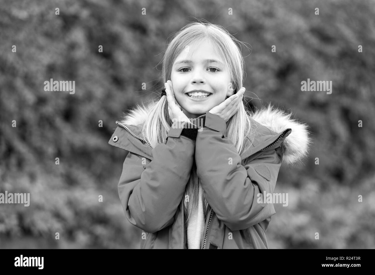 Girl child touch happy face with palms on autumn day on natural ...