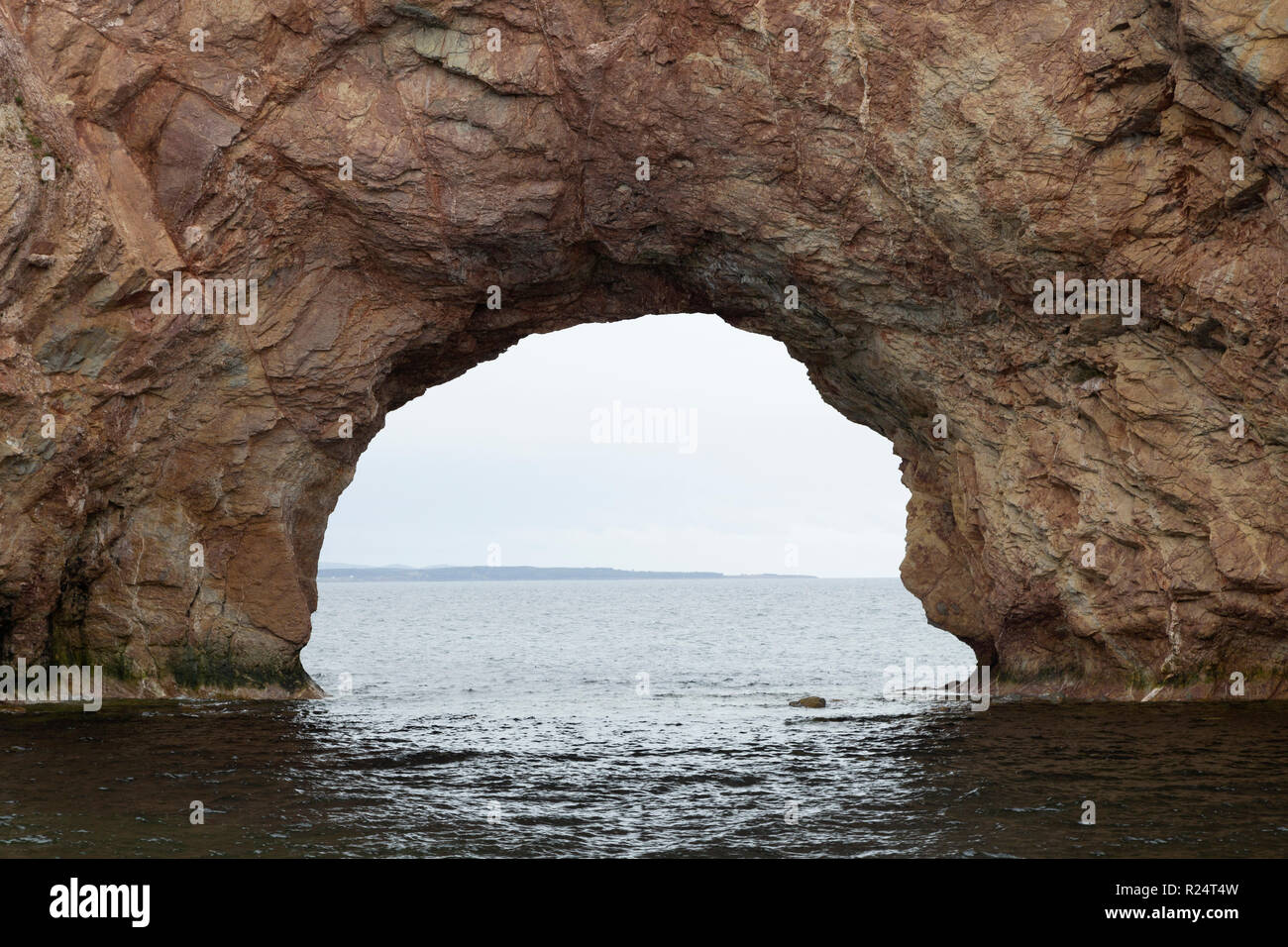 Arch in Perce Rock off the Gaspe Peninsula of Quebec, Canada. The arch ...