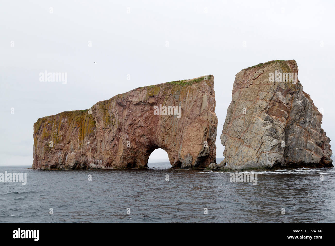 Perce Rock off the Gaspe Peninsula of Quebec, Canada. The rock stands ...