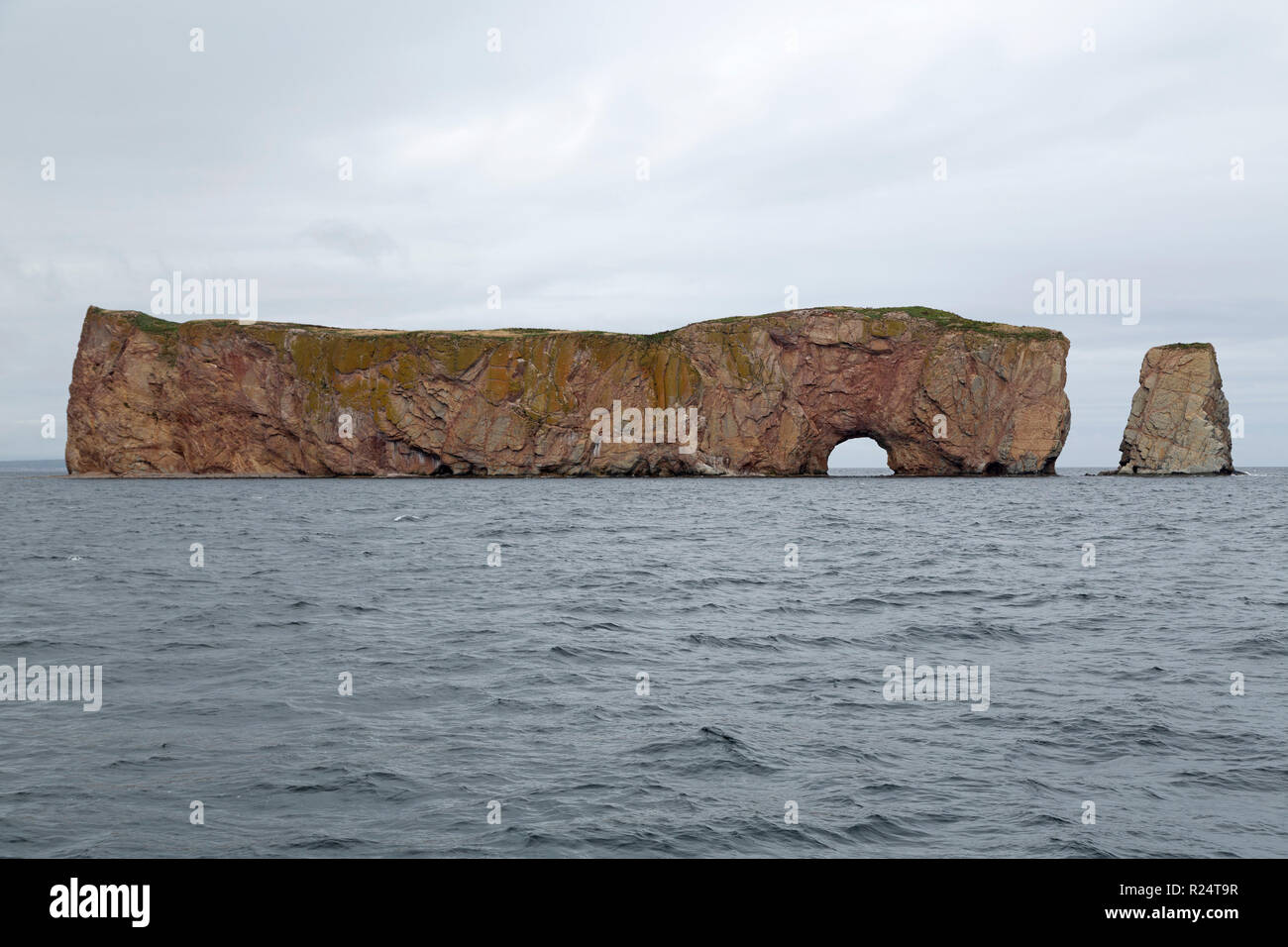 Perce Rock off the Gaspe Peninsula of Quebec, Canada. The rock stands ...