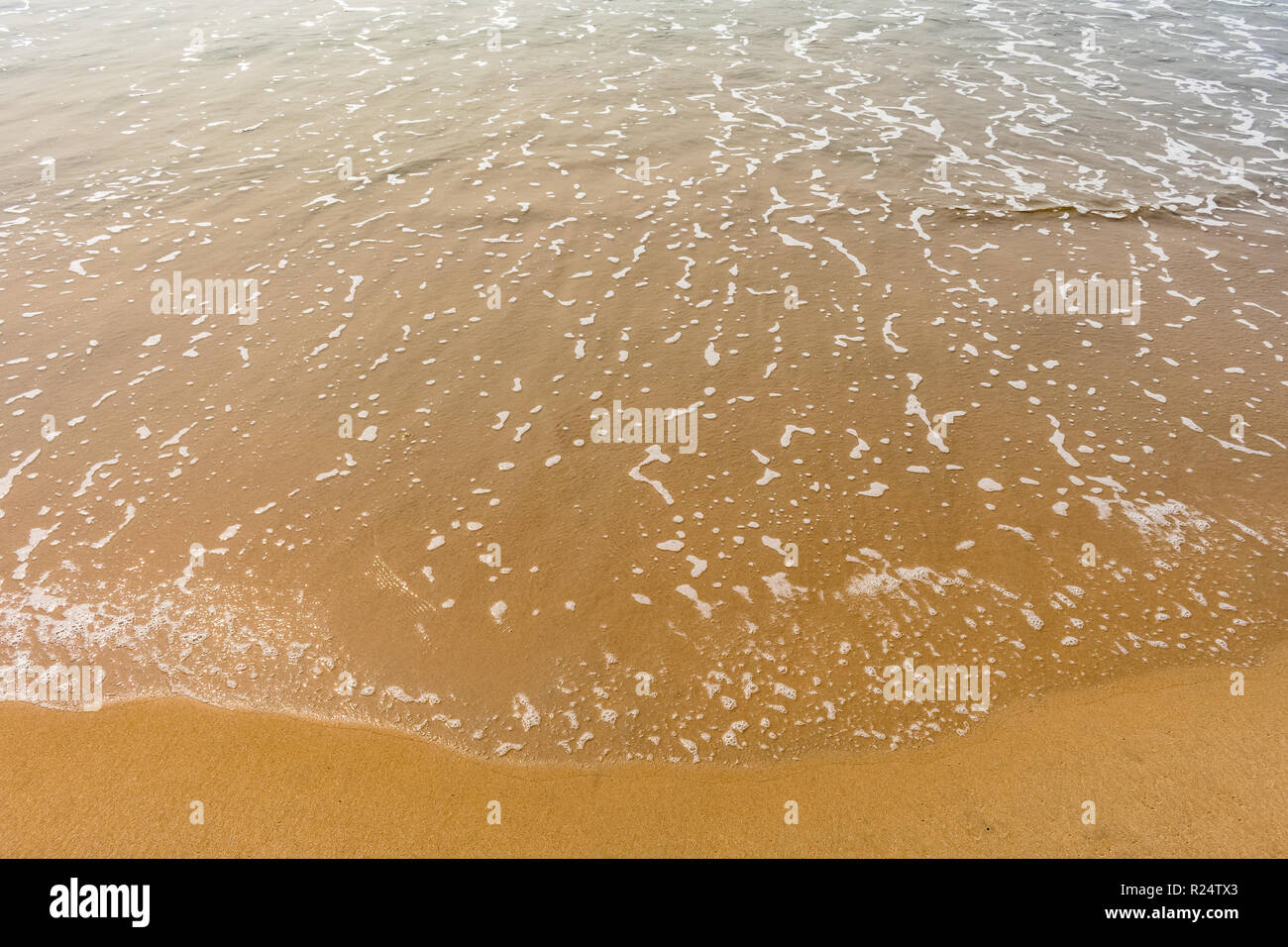 A beautiful pattern of sea water with foam created after collide sea ...