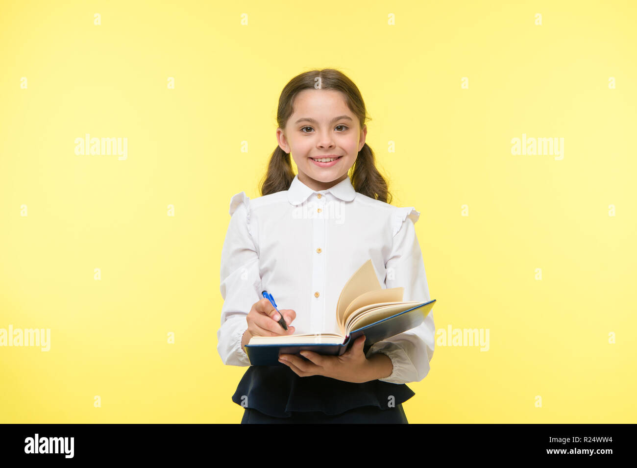Write note to remember. Child school uniform smart kid happy make note ...