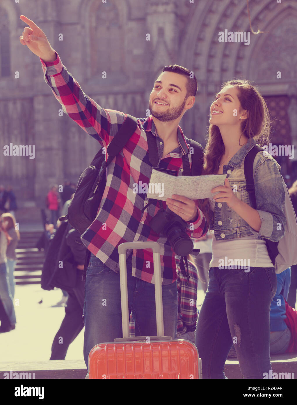Positive young man points the direction at the city Stock Photo - Alamy