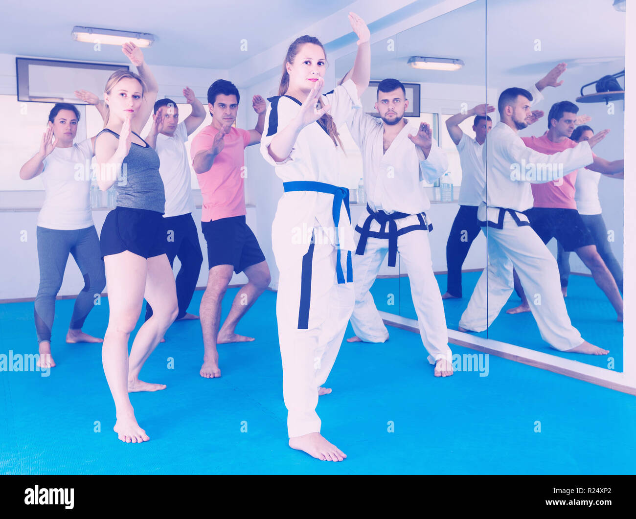 Young italian adults attempting to master new moves during karate class ...