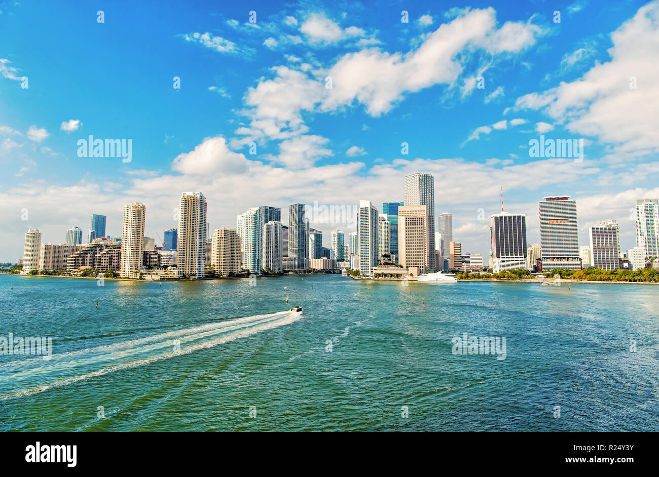 Aerial view of Miami skyscrapers with blue cloudy sky,white boat ...