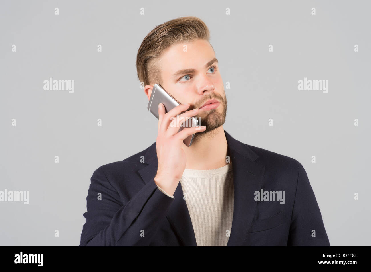 Wait connection. Man well groomed speak mobile phone grey background. Businessman serious call ...