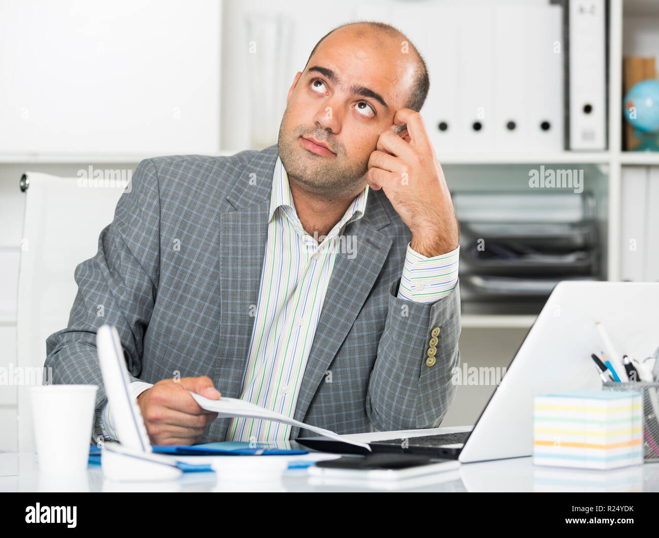 Sad businessman thinking about work in the modern office Stock Photo ...