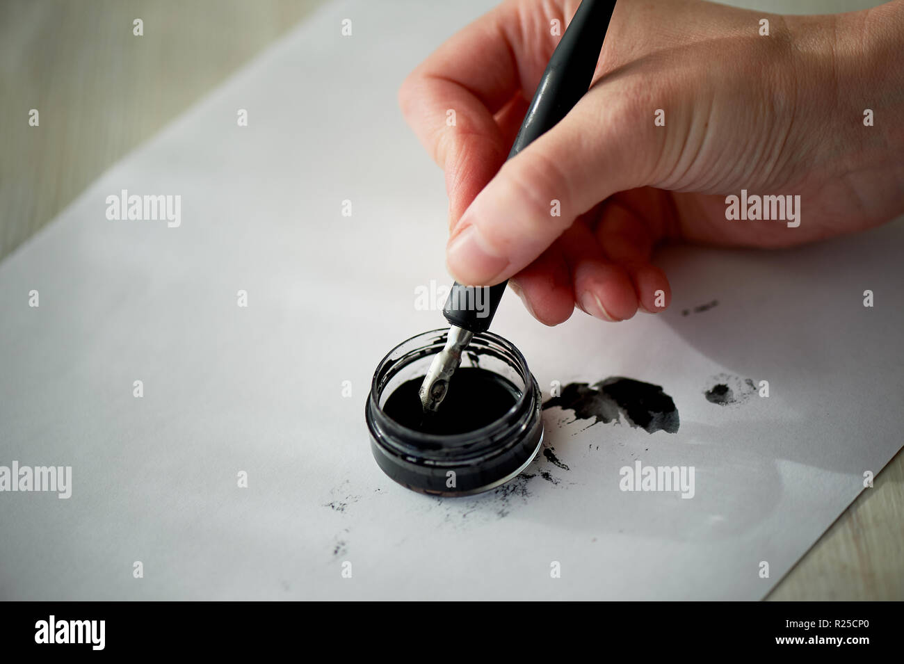 A woman's hand writes with ink, a fountain pen. Writing. The creative ...
