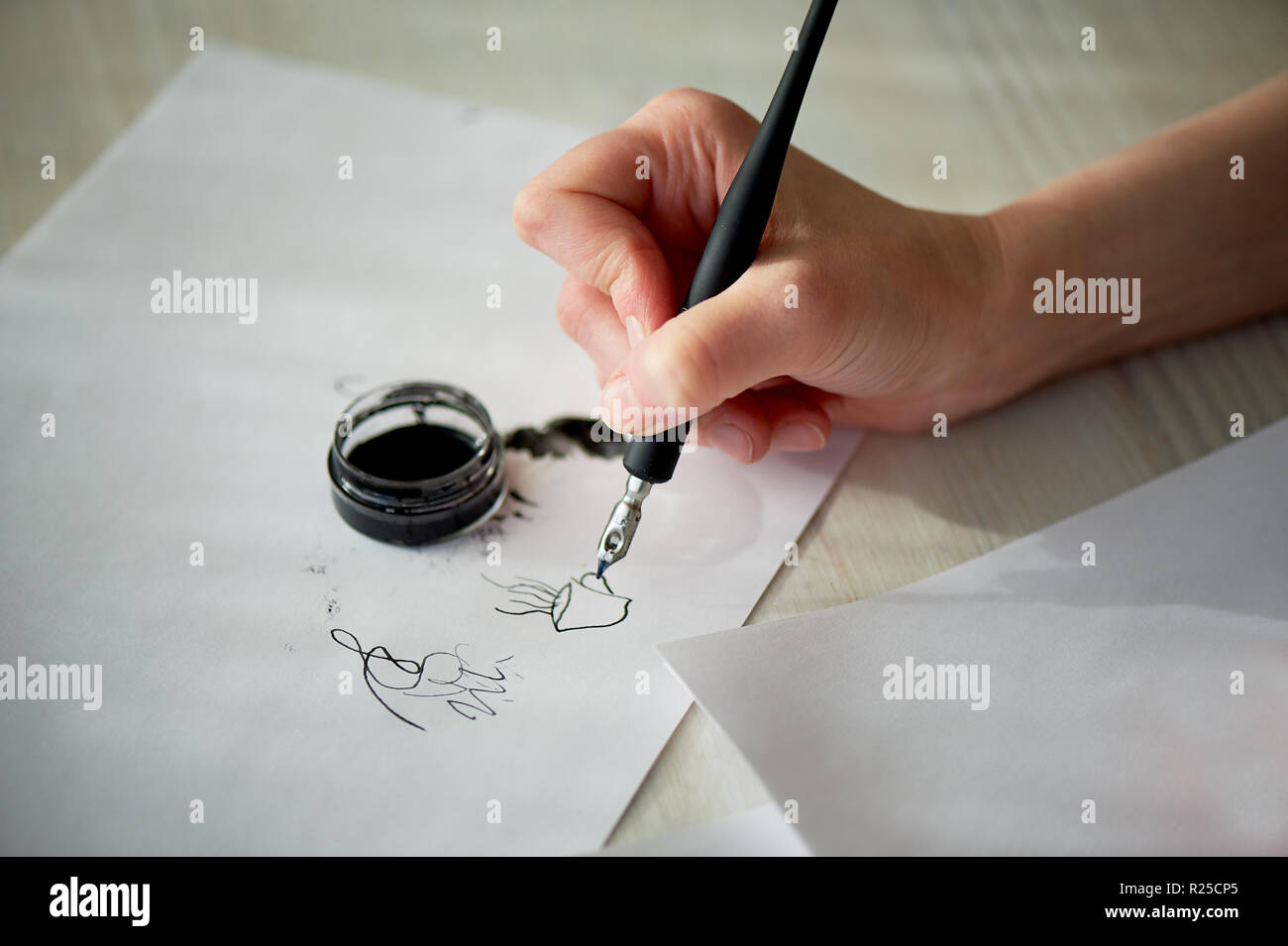 A woman's hand writes with ink, a fountain pen. Writing. The creative ...