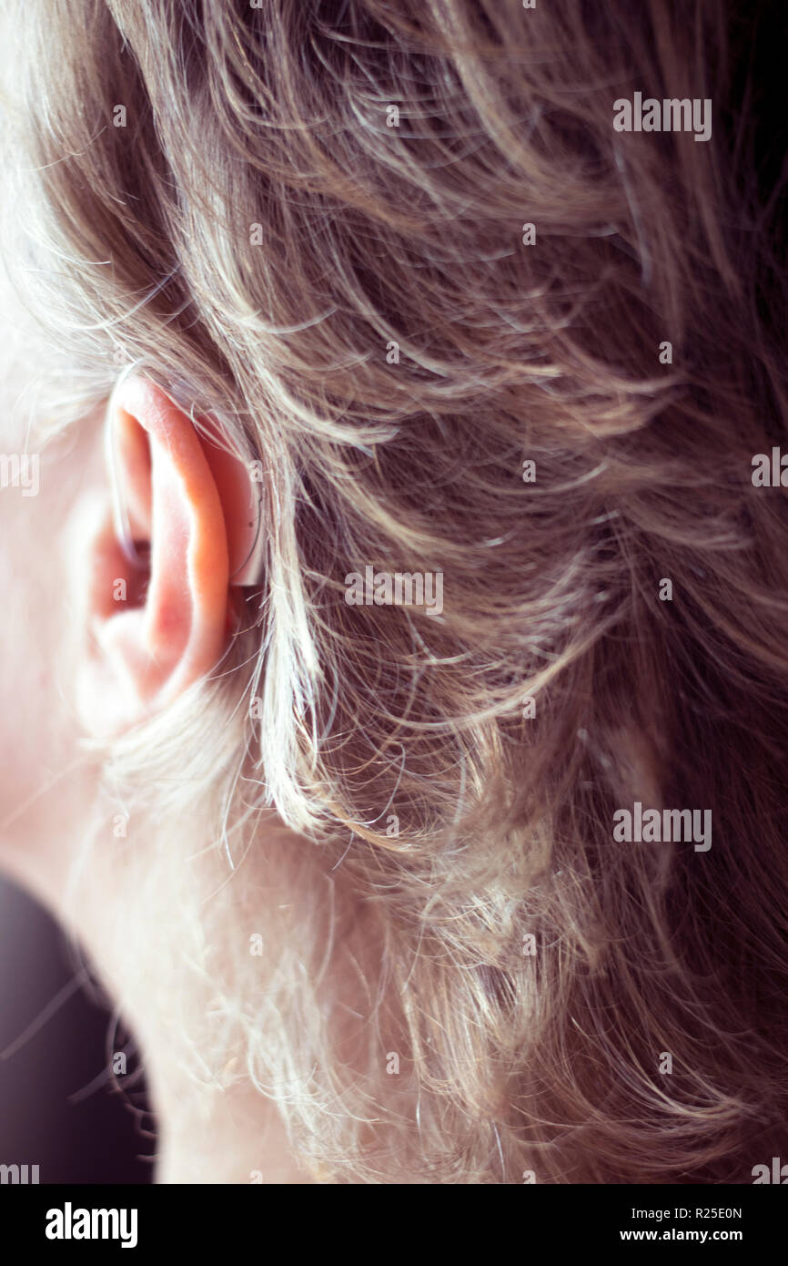 Deaf lady with modern technology digital hearing aid in her ear Stock ...
