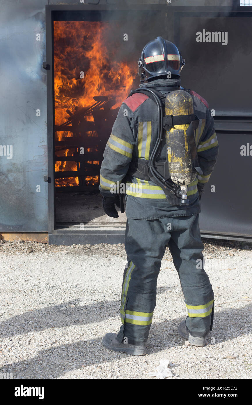 Firefighter putting out fire training station extinguisher backdraft ...