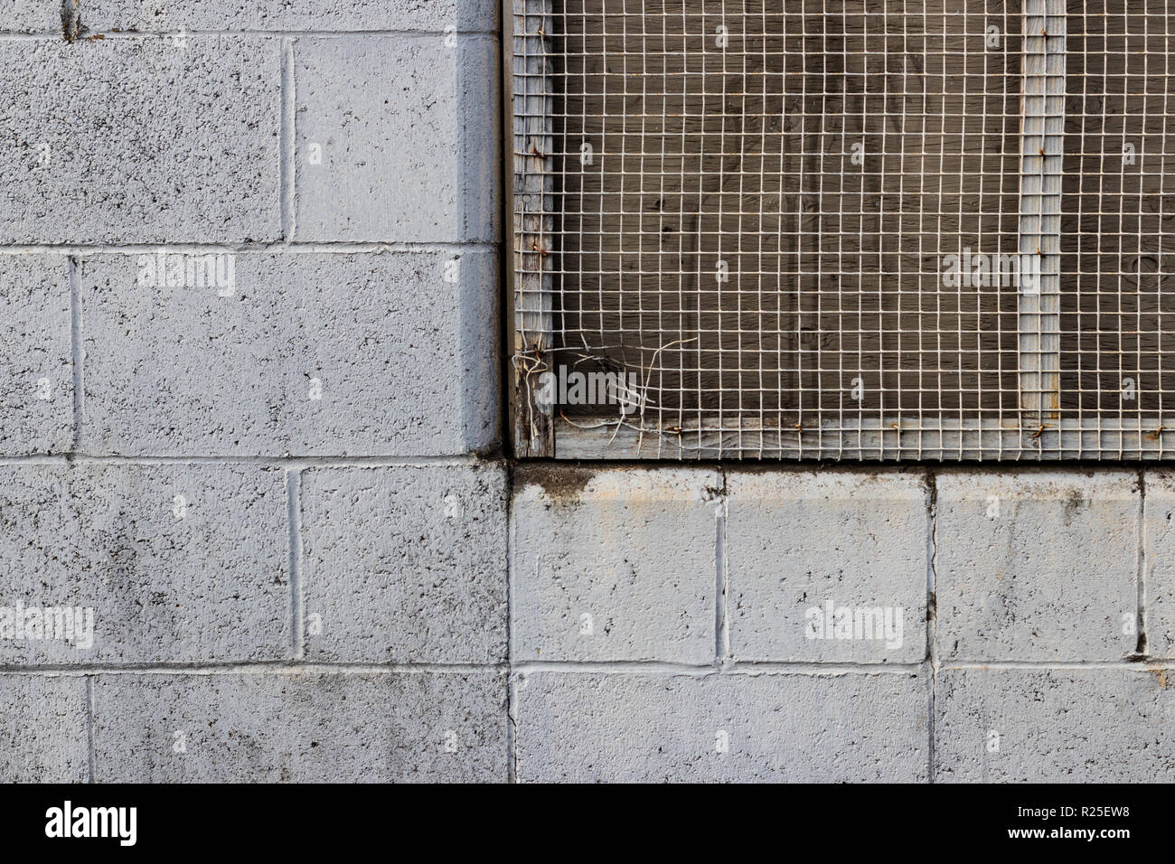 Old rocky wall with chain grated window hole Stock Photo - Alamy
