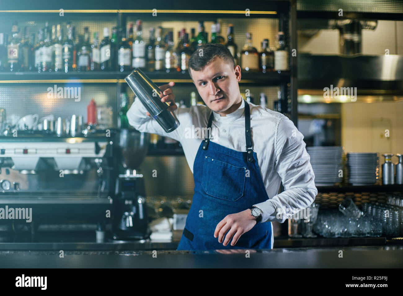 Bartender professionally working with shaker and making good drinks ...