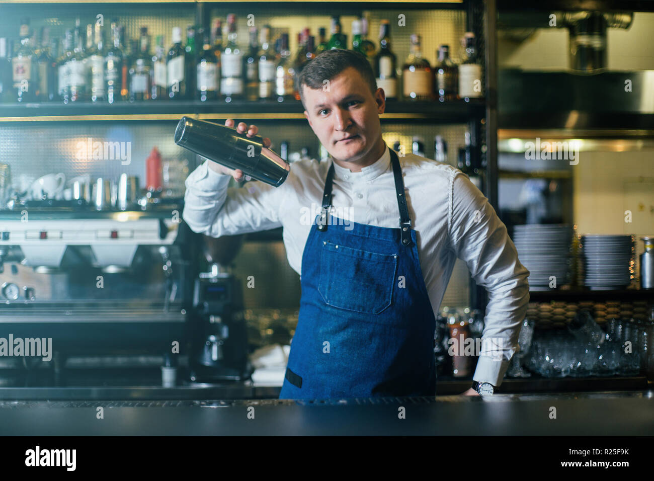 Bartender professionally working with shaker and making good drinks ...