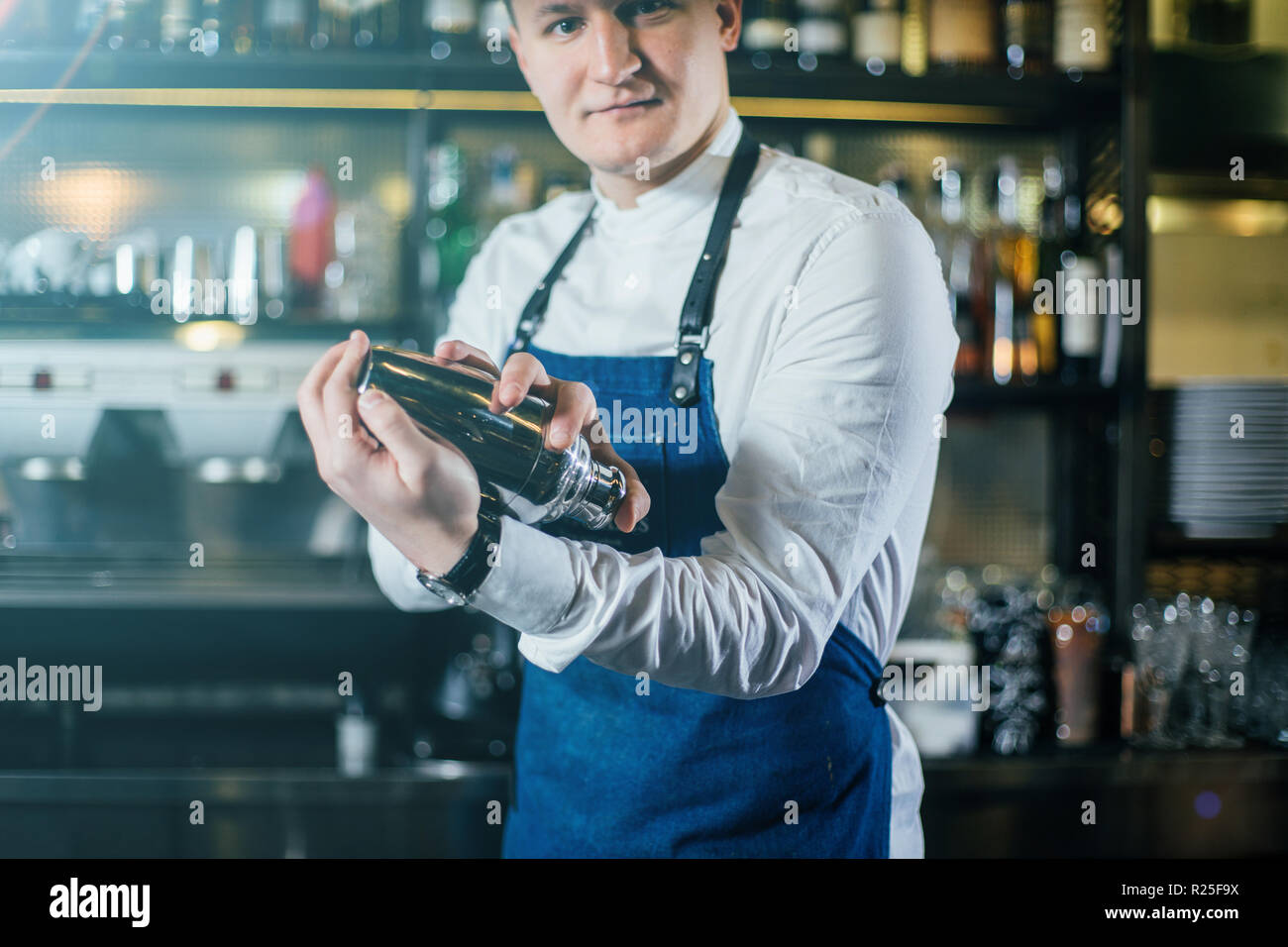 Bartender professionally working with shaker and making good drinks ...